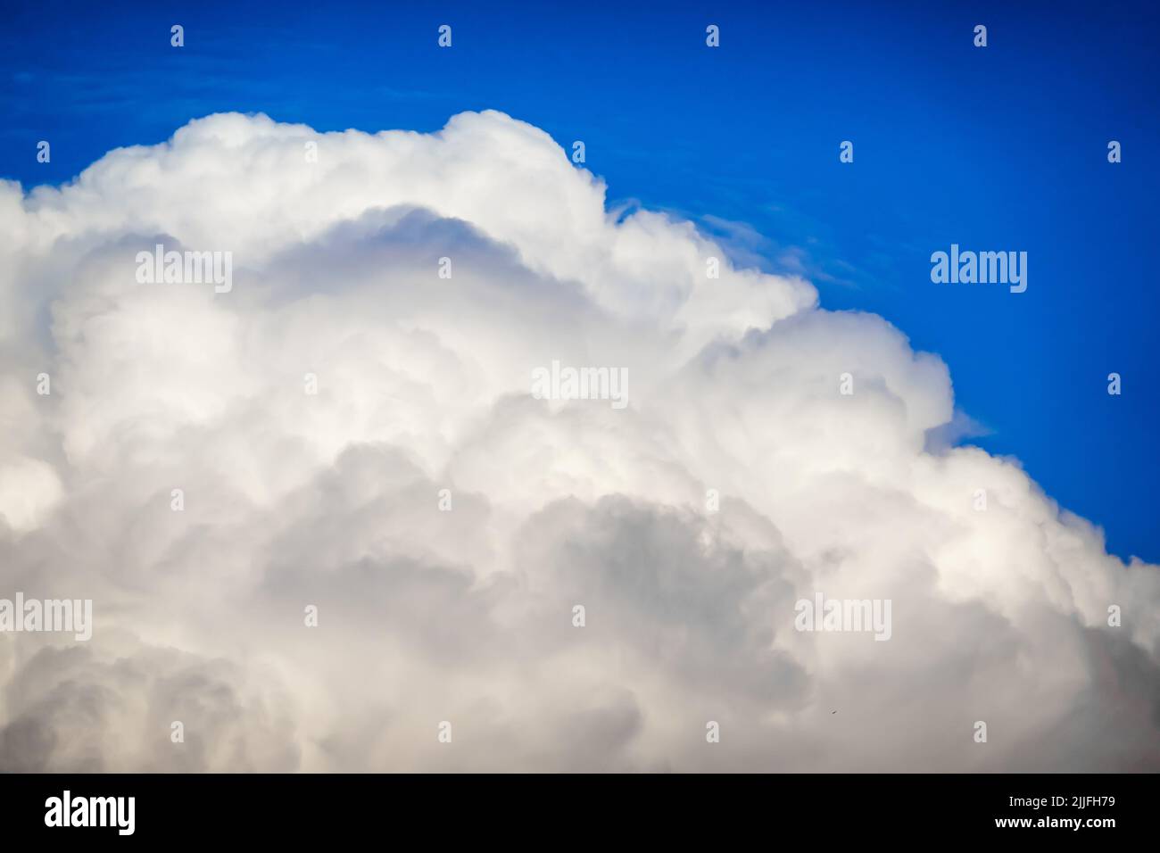 Fluffy clouds floating in blue sky Stock Photo - Alamy