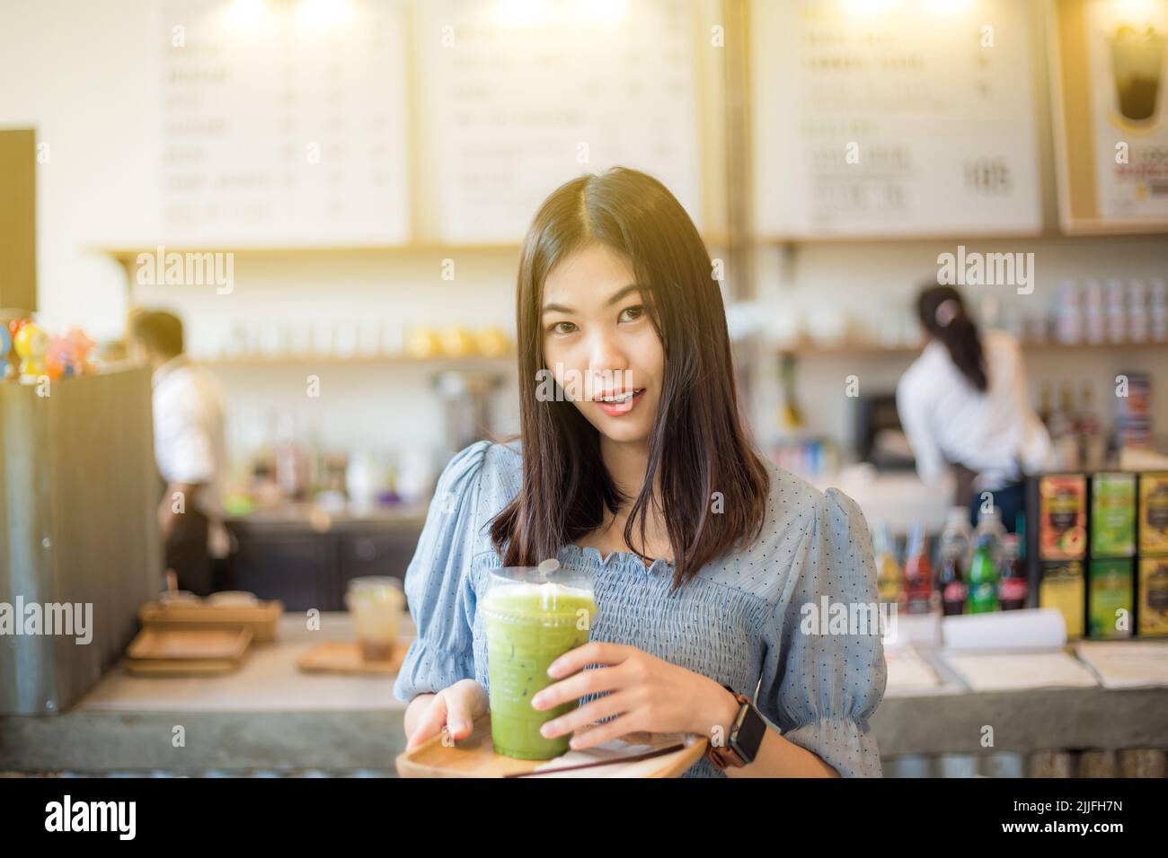 Happy smiling asian women drinking with ice matcha green tea indoor ...