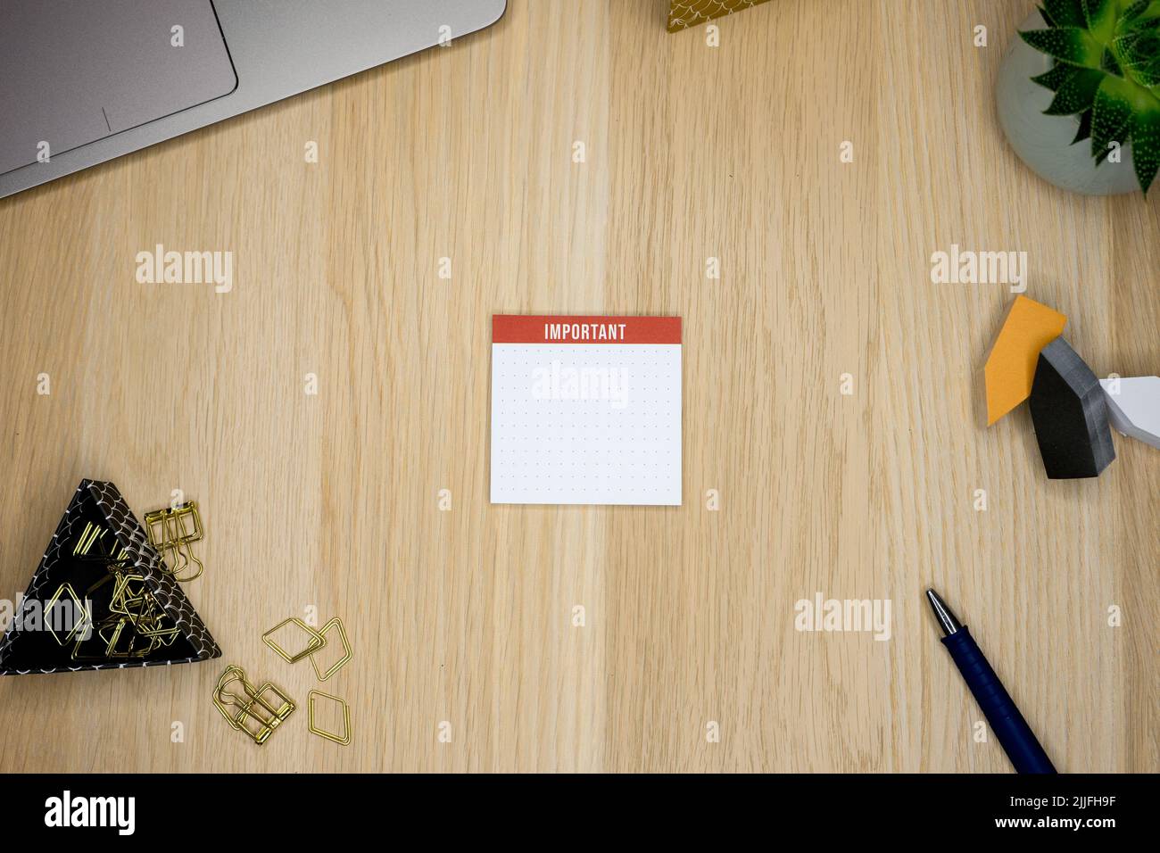 A top view of a notepad for important notes on a cluttered office desk ...