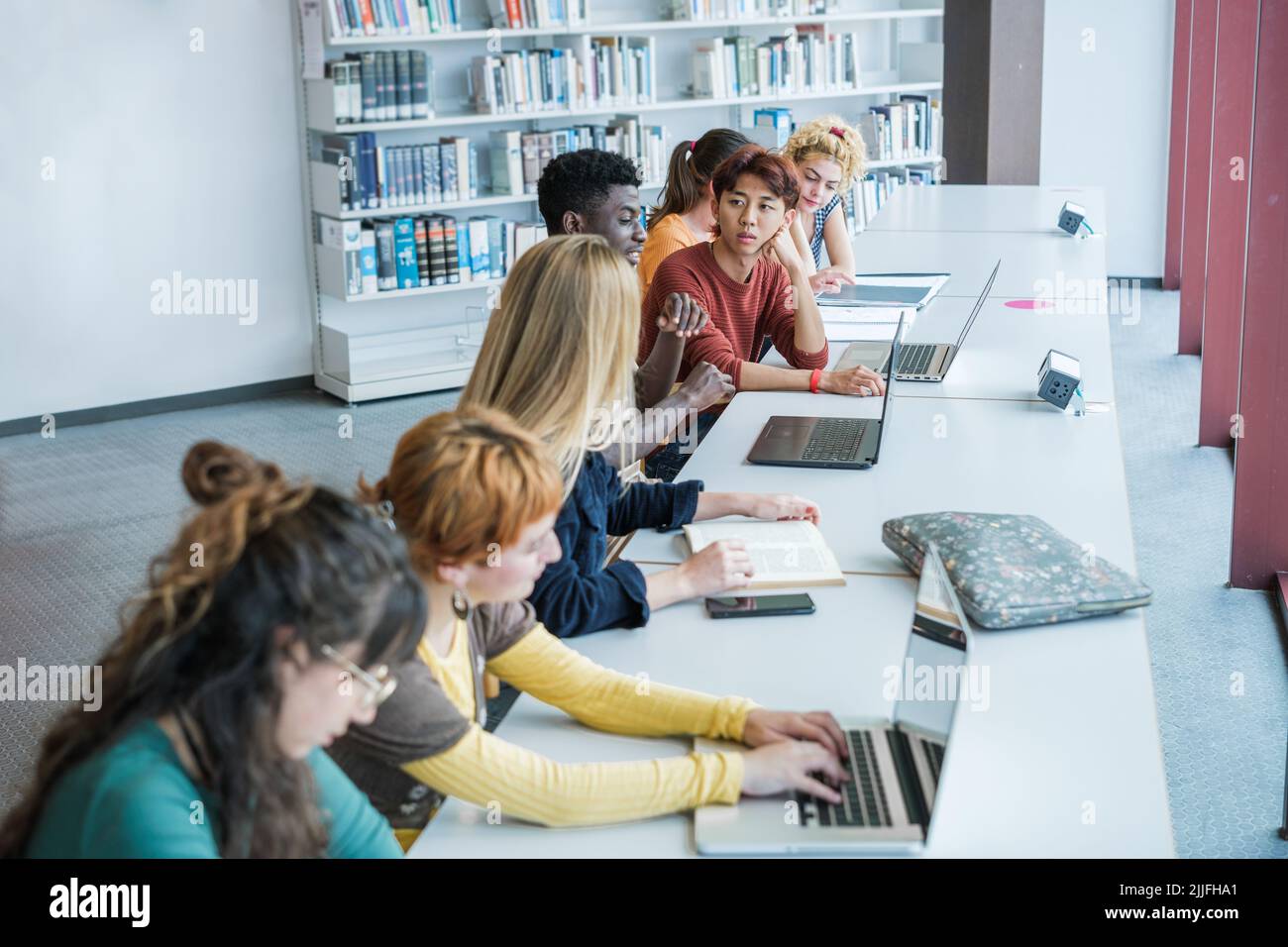 Group of college students studying at university - focus on young asian ...