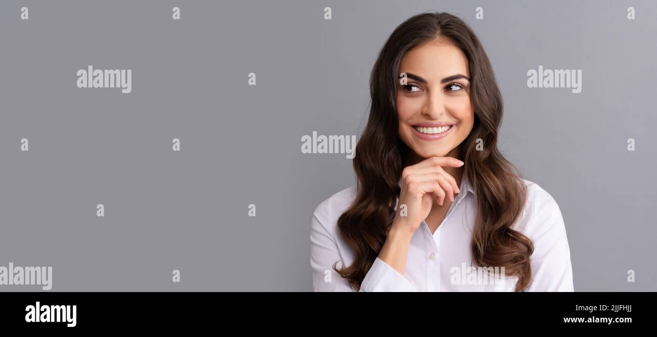 Thoughtful professional woman employee think smiling grey background ...