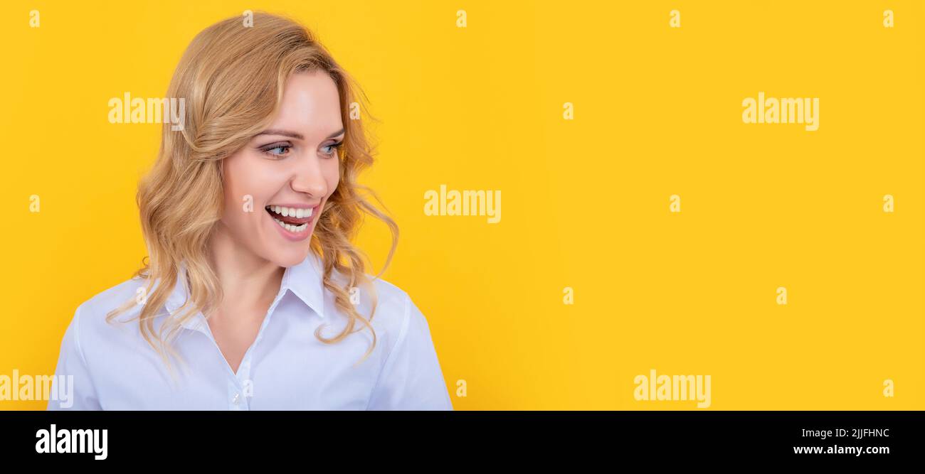 happy blonde woman with curly hair on yellow background. Woman isolated ...