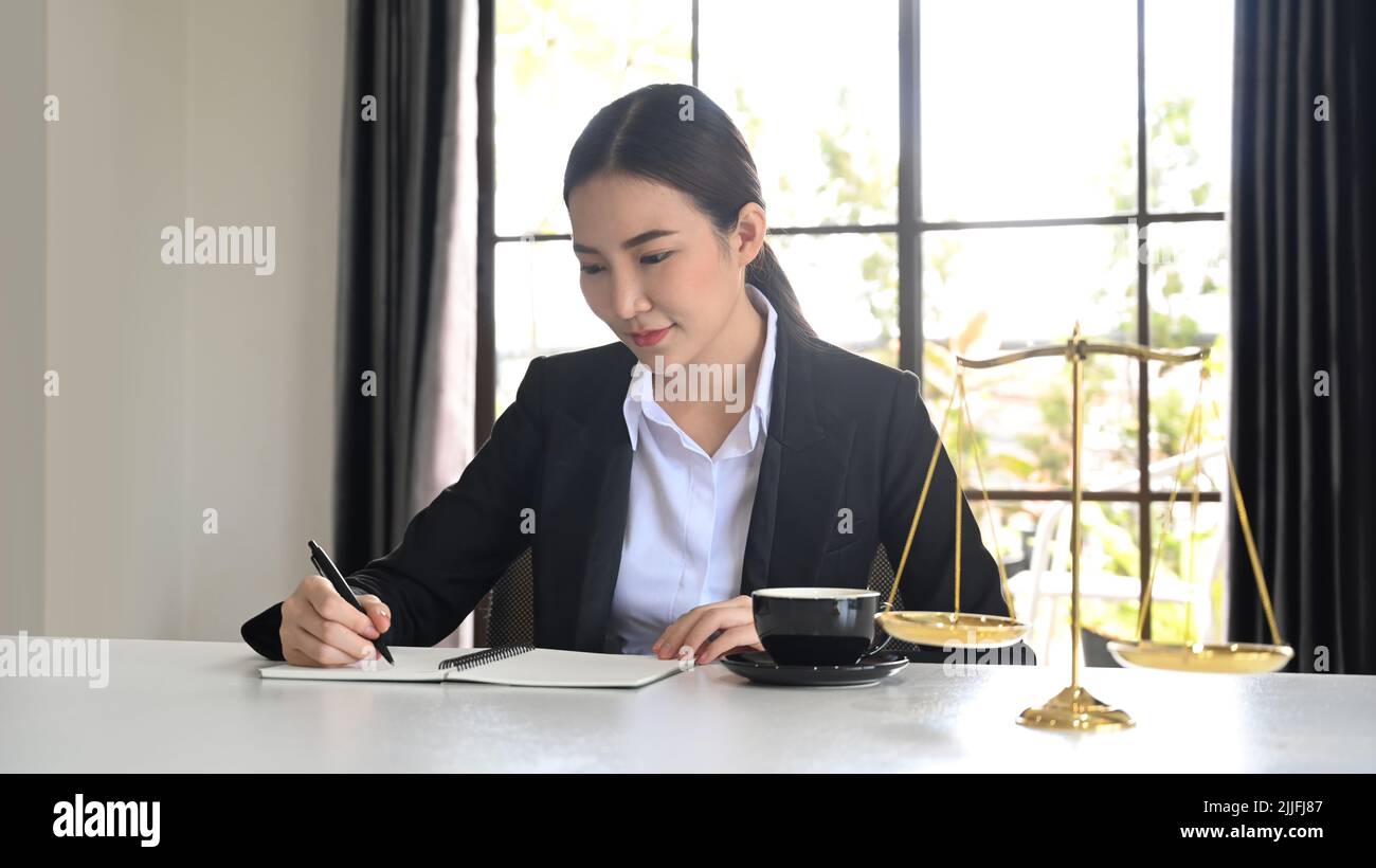 Female lawyers working with contract papers in the office and brass scale on white table Stock ...