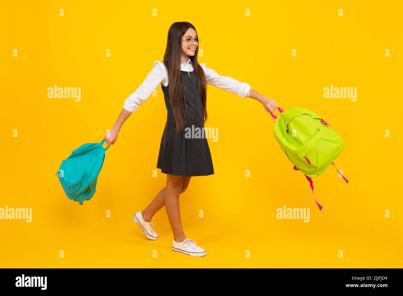 Schoolgirl in school uniform with school bag. Schoolchild, teen student ...