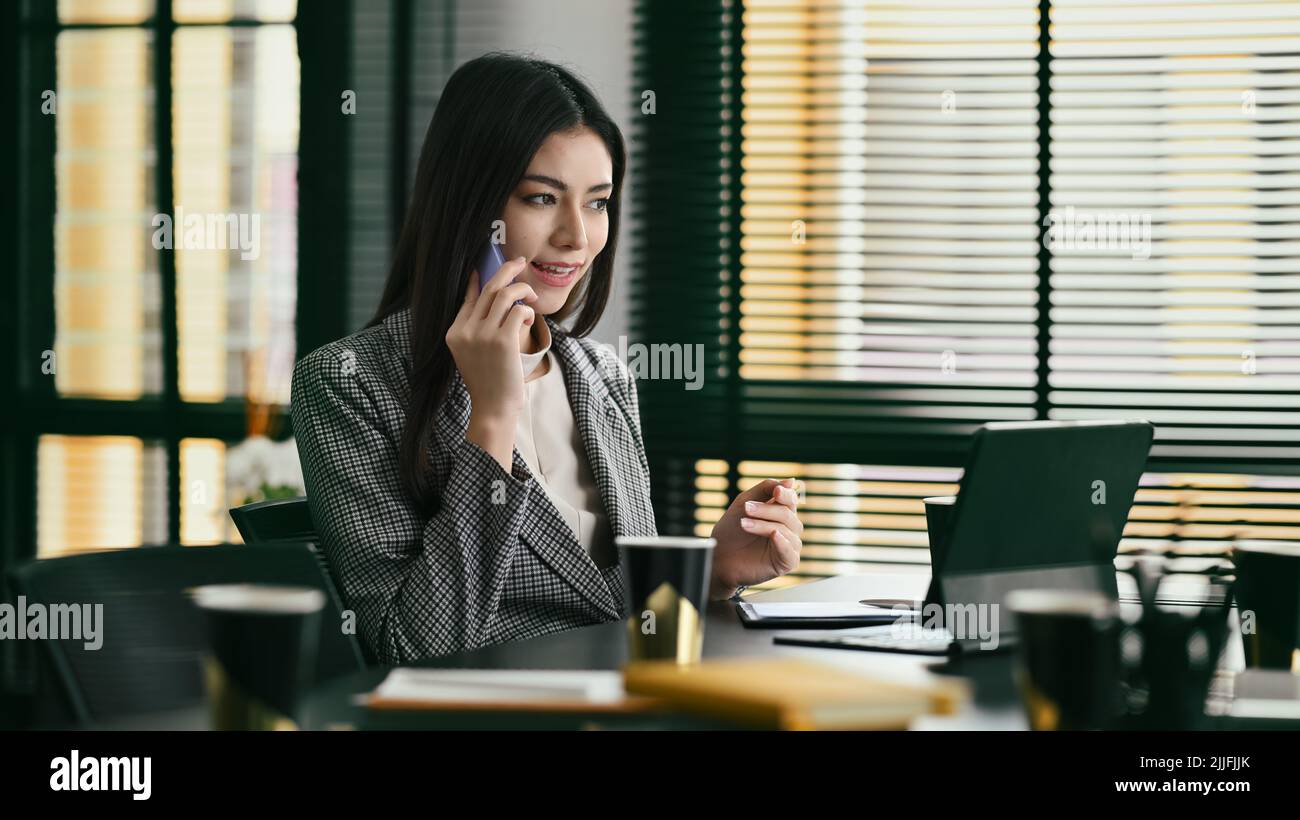 Confident female financial advisor having phone conversation, giving ...