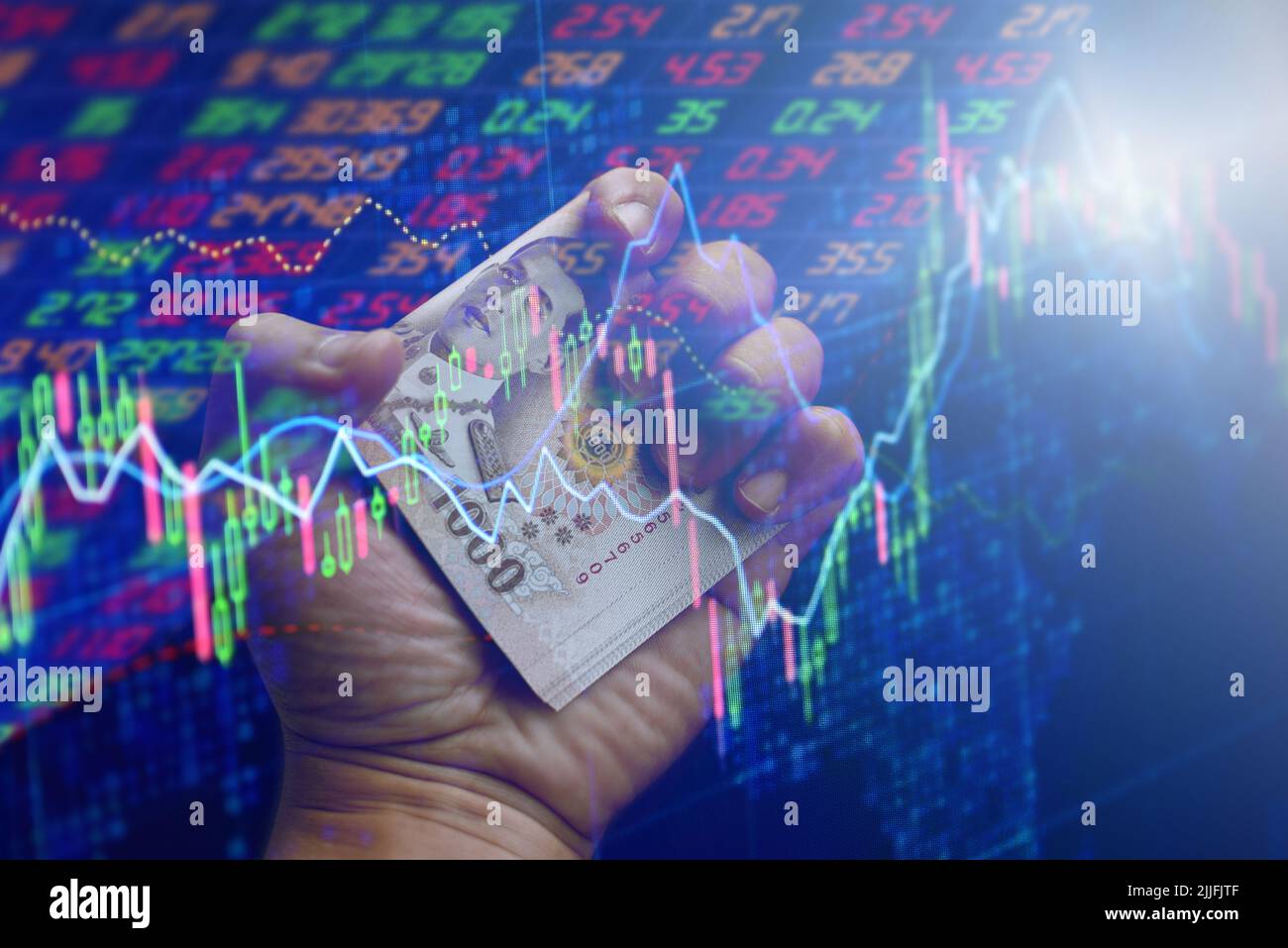 money Thai 1000 baht banknotes in hand. and stock chart trading ...