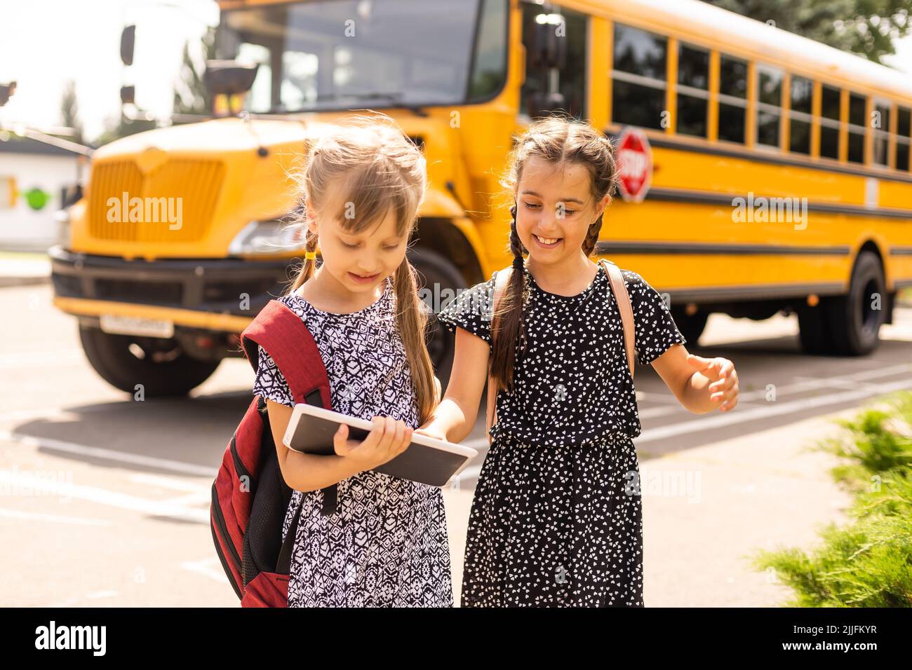 adorable schoolchildren running to school bus Stock Photo - Alamy