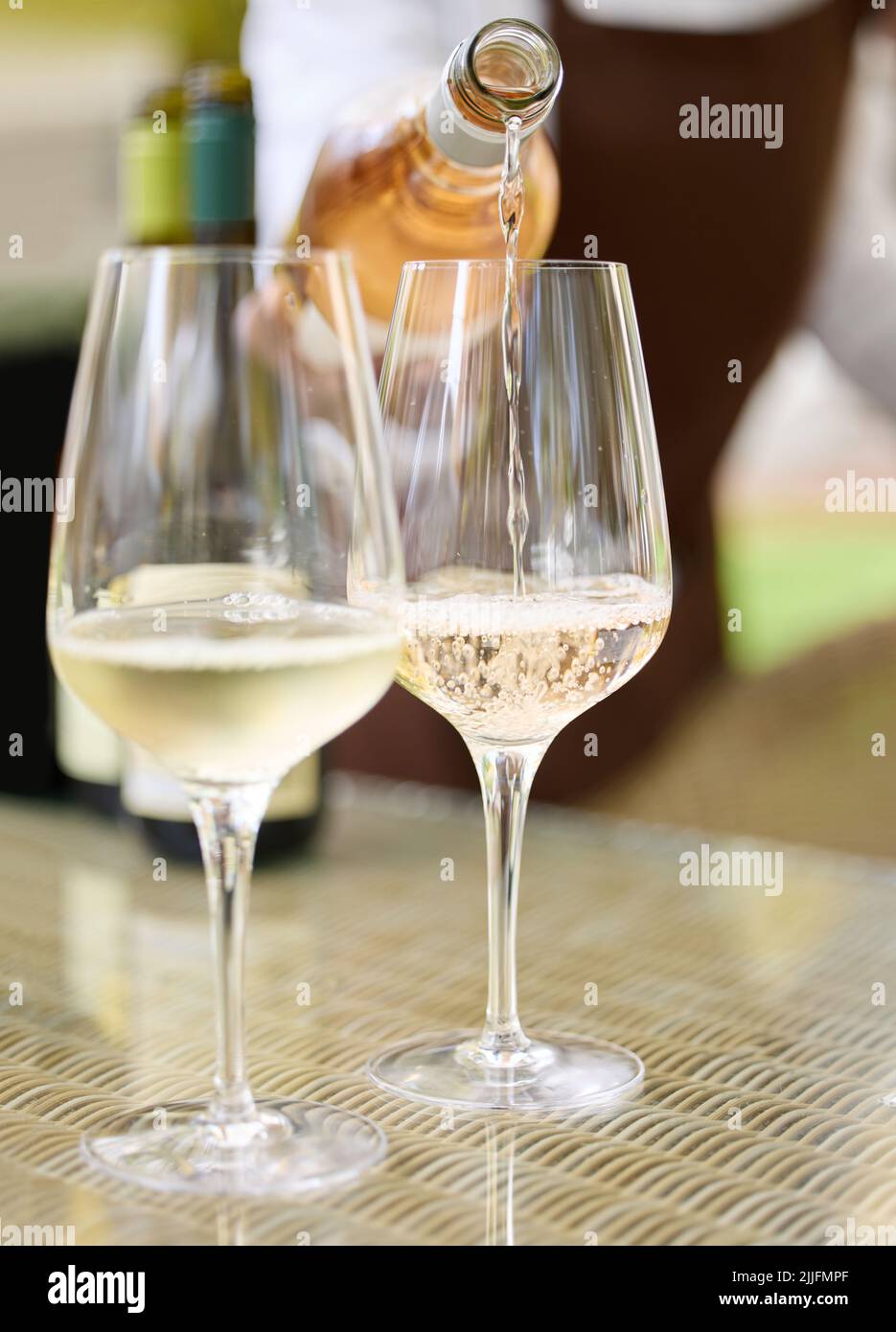 Try our house wine. an unrecognisable waiter pouring wine into a glass ...