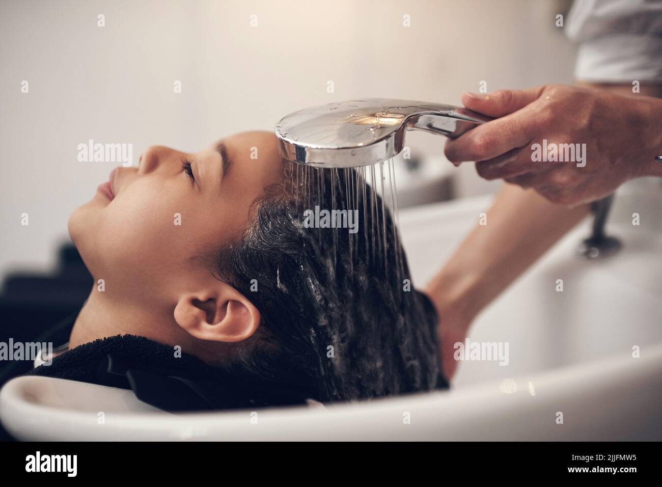 At the salon is the only place I love getting my hair washed. a young ...