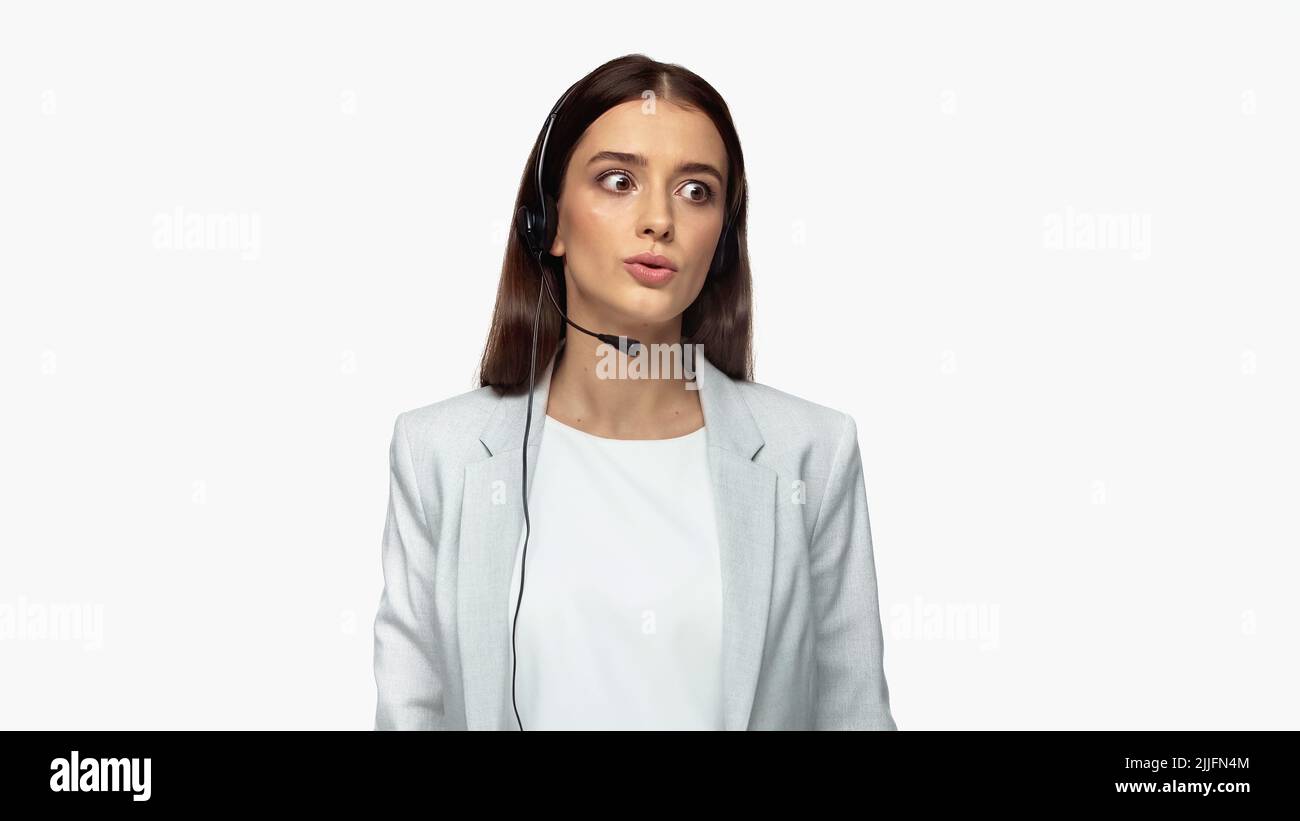 young operator in headset with microphone and grey blazer talking ...