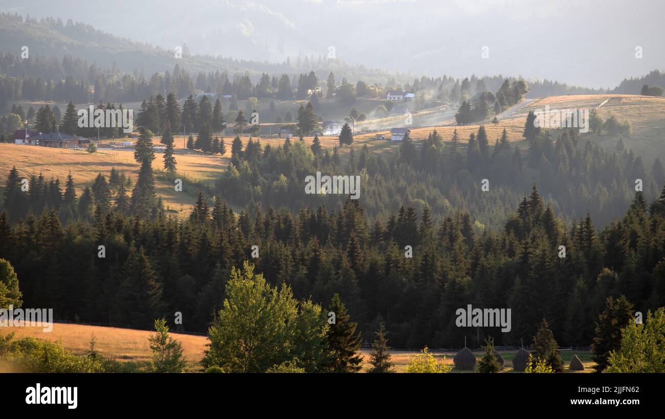 Magic summer sunset over the mountain village at Tihuta, Piatra ...