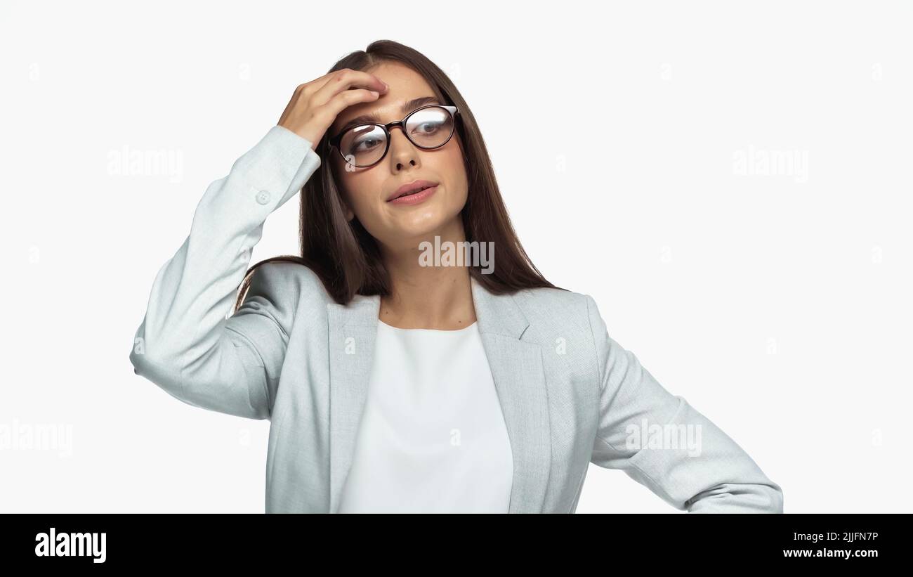 tired businesswoman in grey blazer and eyeglasses isolated on white ...