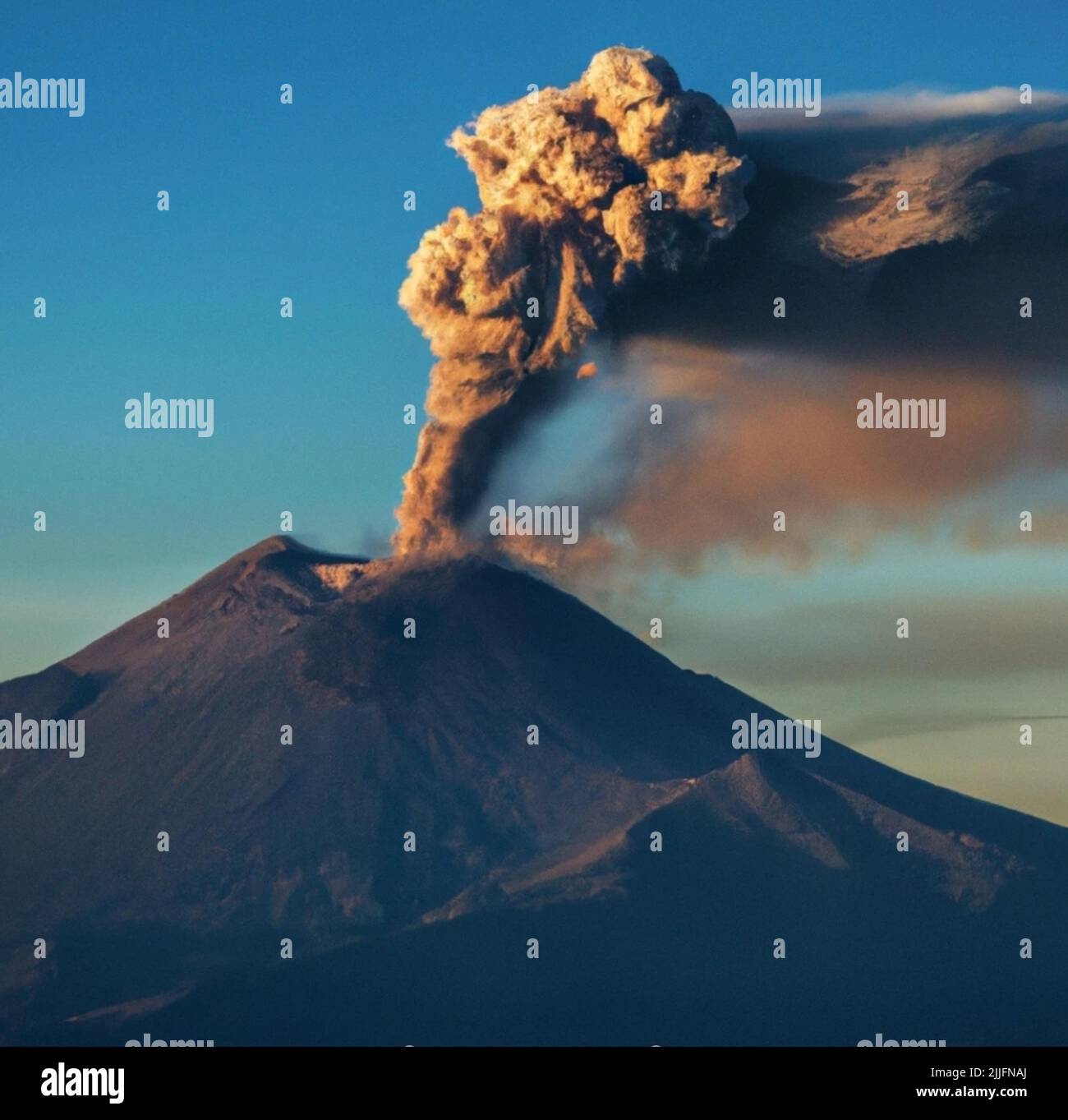 A breathtaking view of a volcano erupting against a blue sky at sunset ...