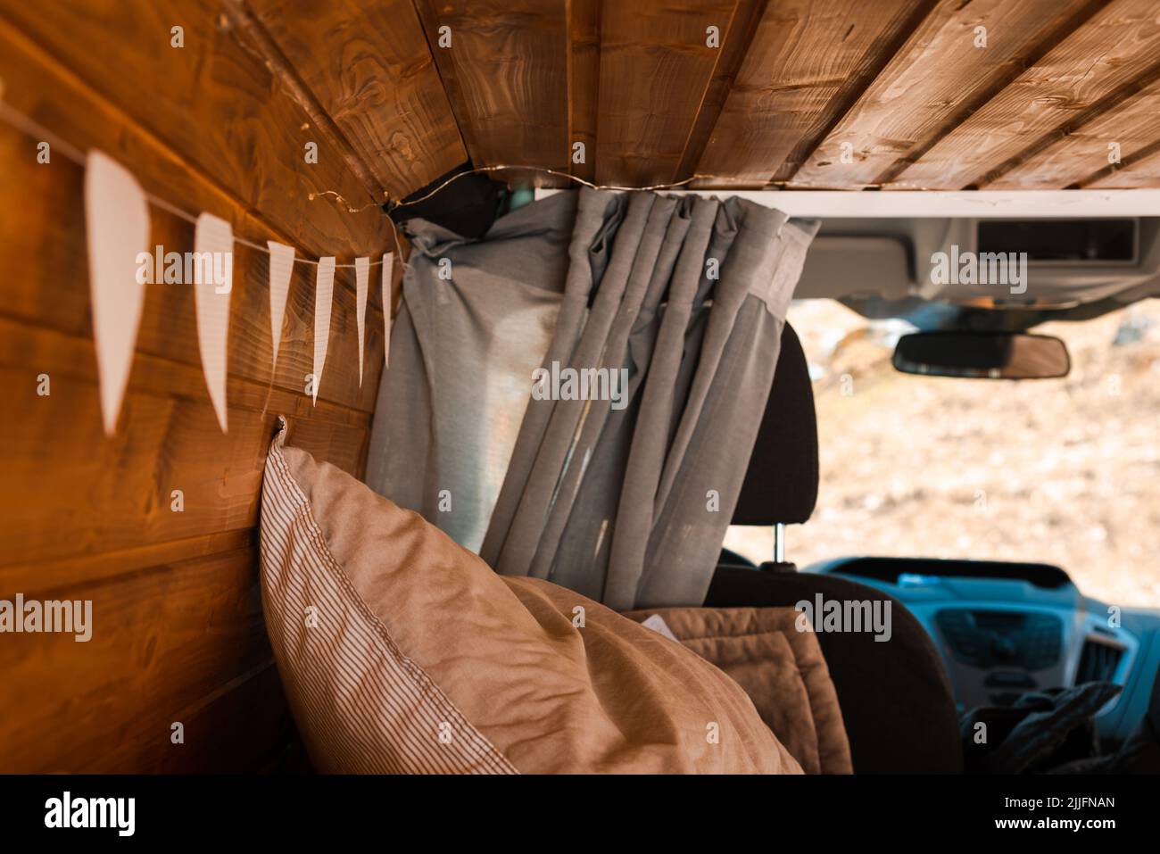 An inside view of a camping van with pillows and decorations Stock ...