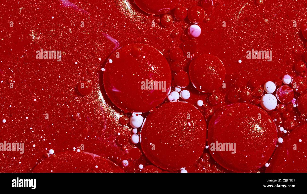 Top view abstract of blood red bubbles or paint. Inks, spheres, oil ...