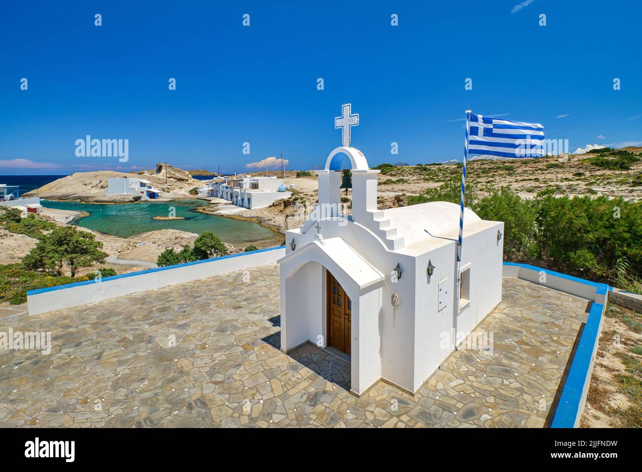 White Greek Orthodox chapel or church, white cross and Greek national ...