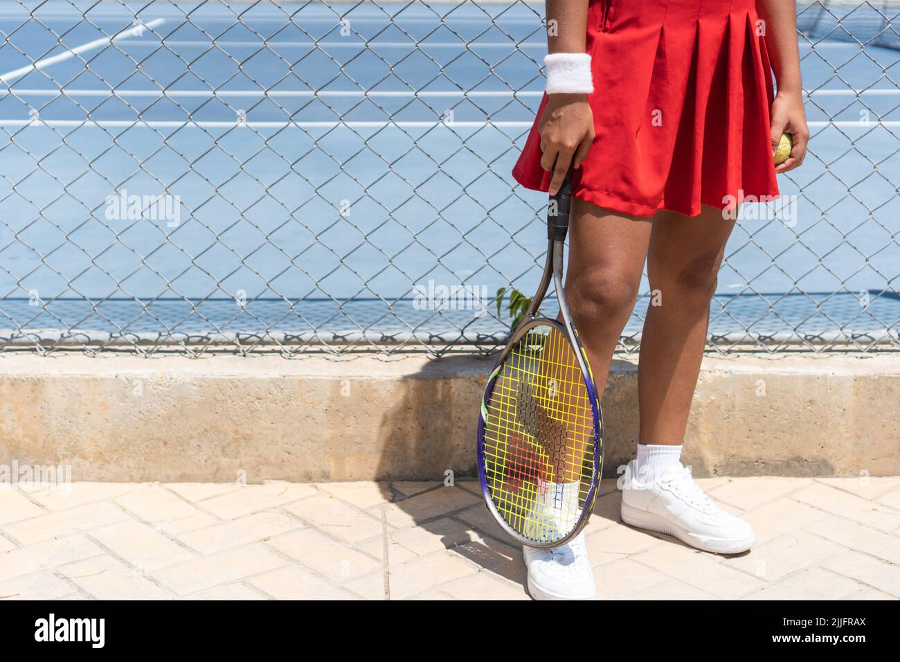 Tennis player standing with racket Stock Photo - Alamy