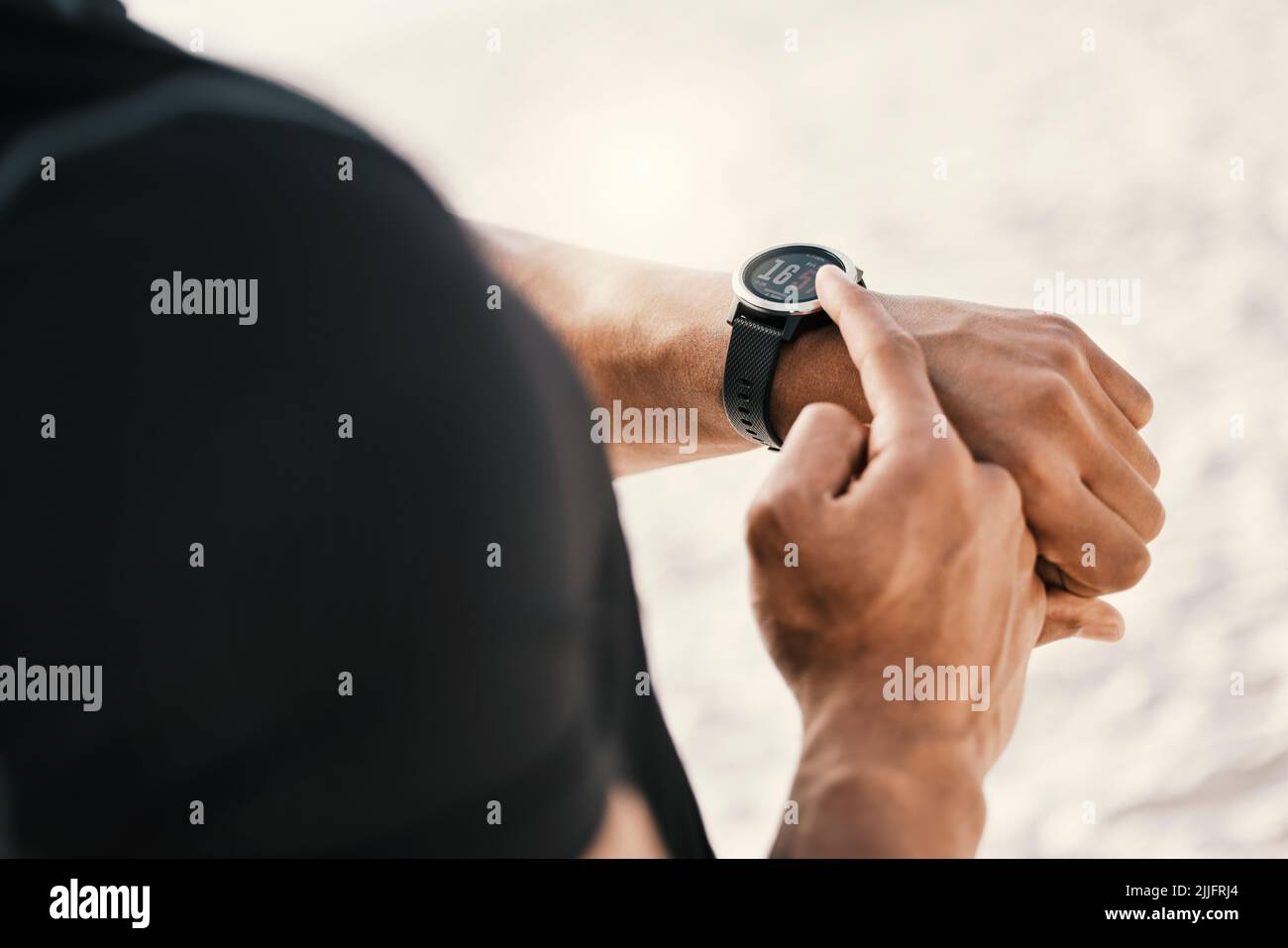 Set goals then crush them. an unrecognizable man checking his watch ...