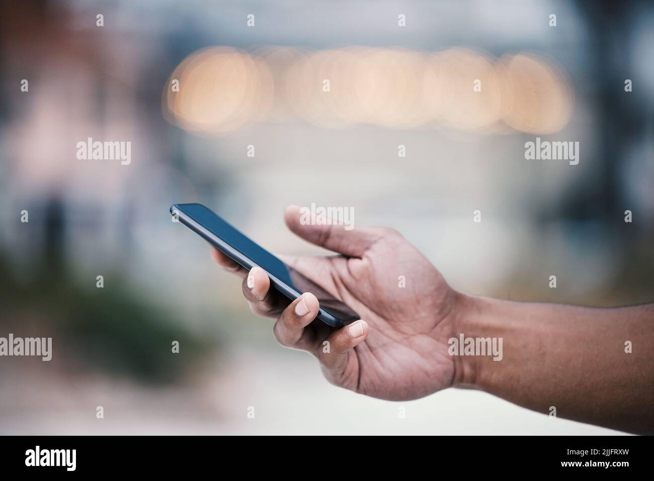 Download this app. an unrecognizable man using his cellphone while ...