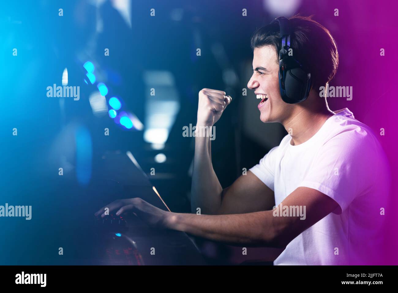 You have to press play to win. a young man cheering while playing ...