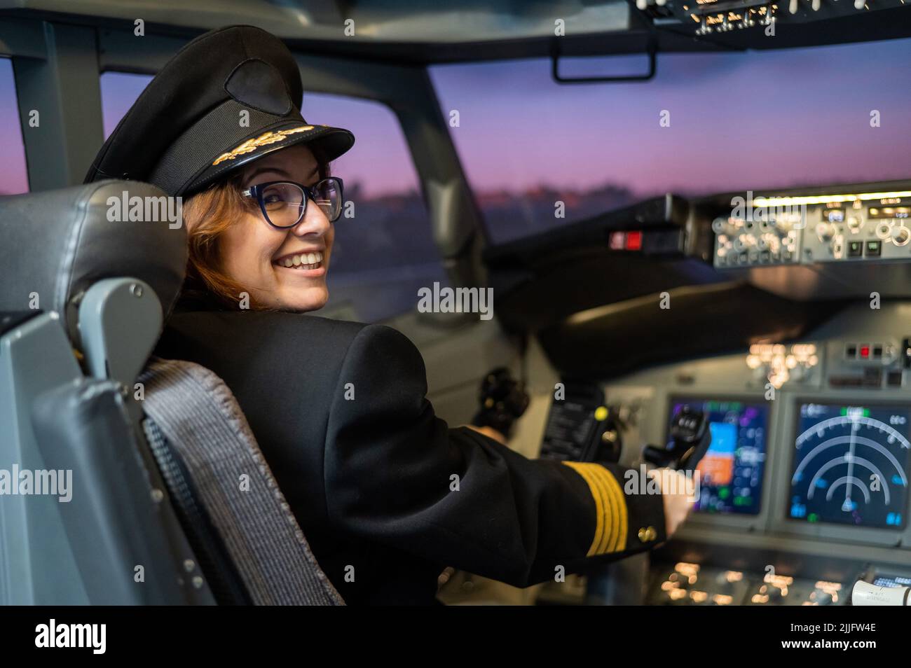 Female pilot on board the aircraft. Caucasian woman in flight simulator ...