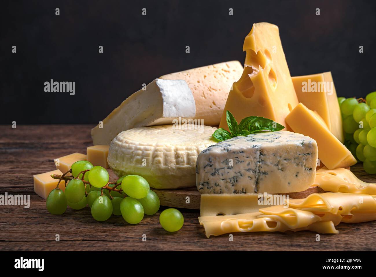 Assortment of different types of cheeses on a black background Stock ...