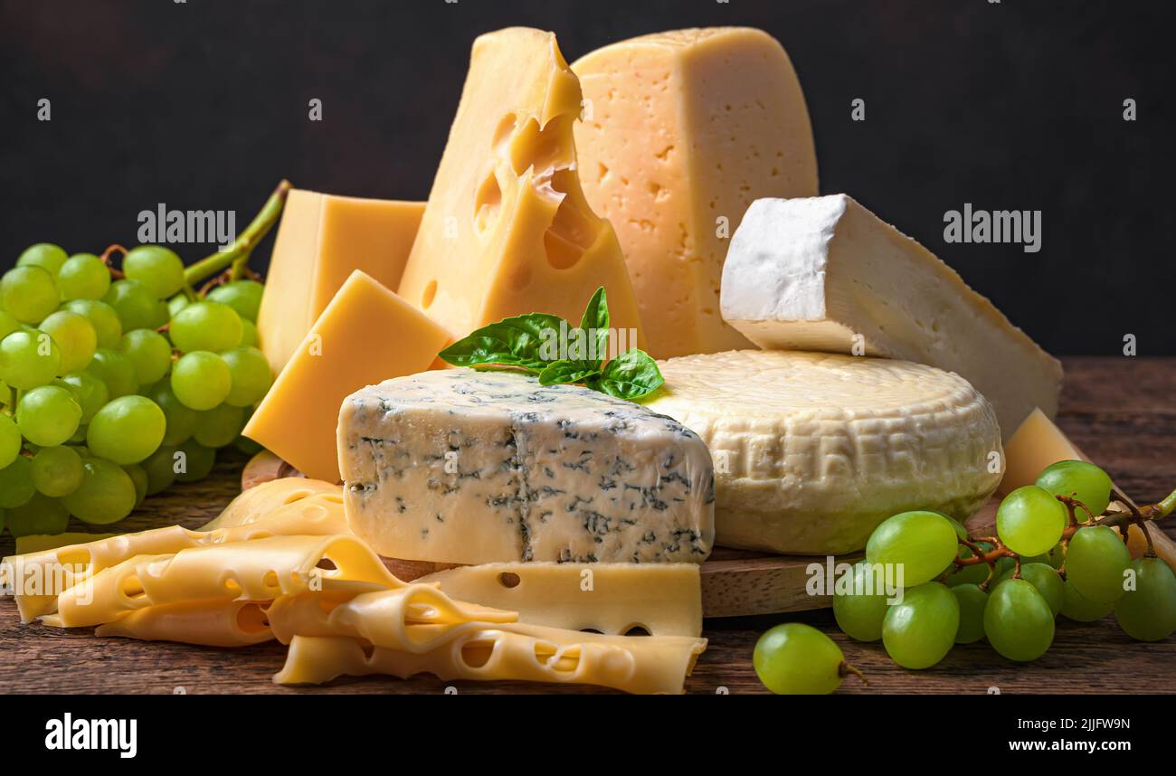 Different types of sarah and fresh grapes on a wooden background close ...