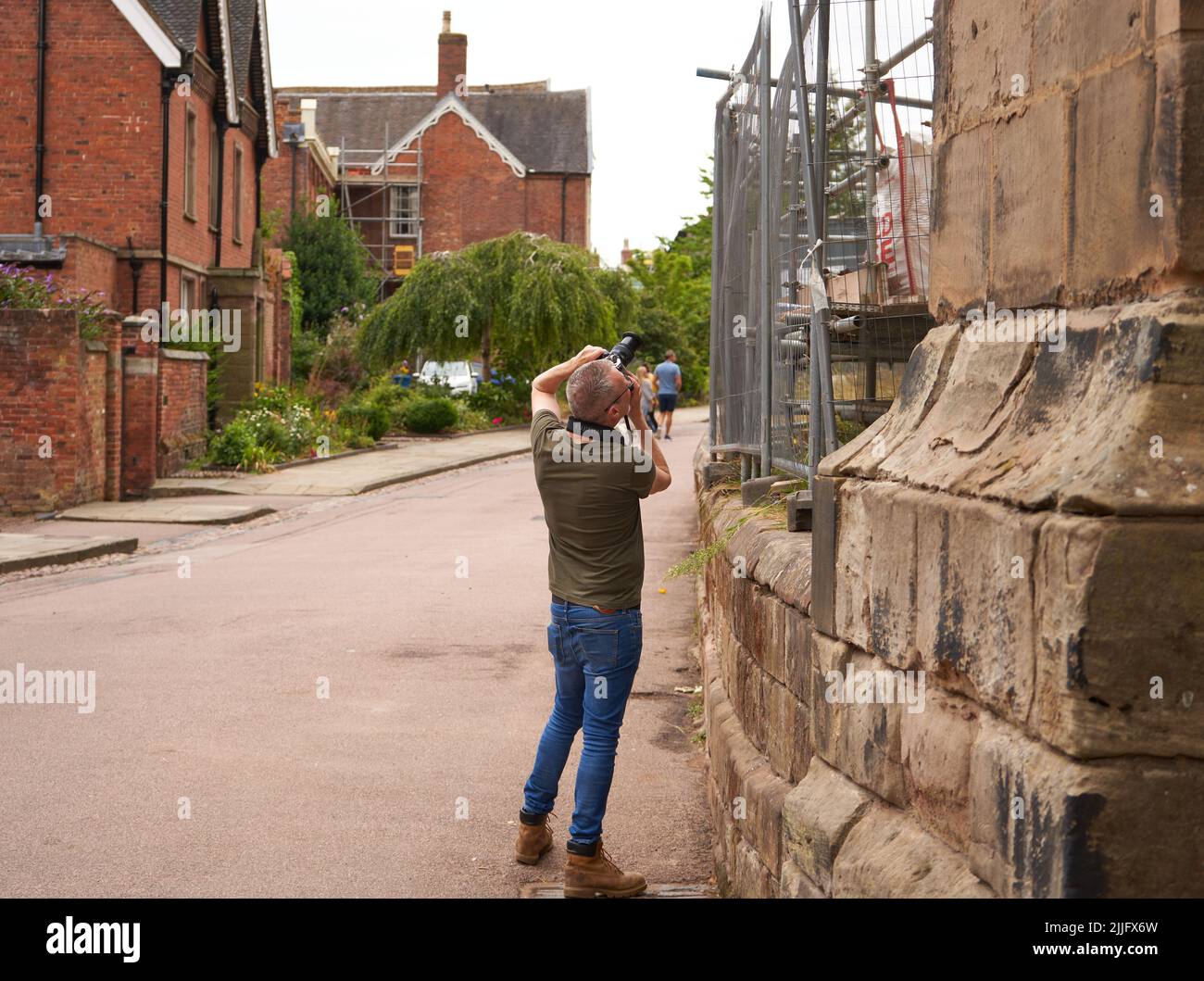 Man looking upwards taking photographs Stock Photo - Alamy