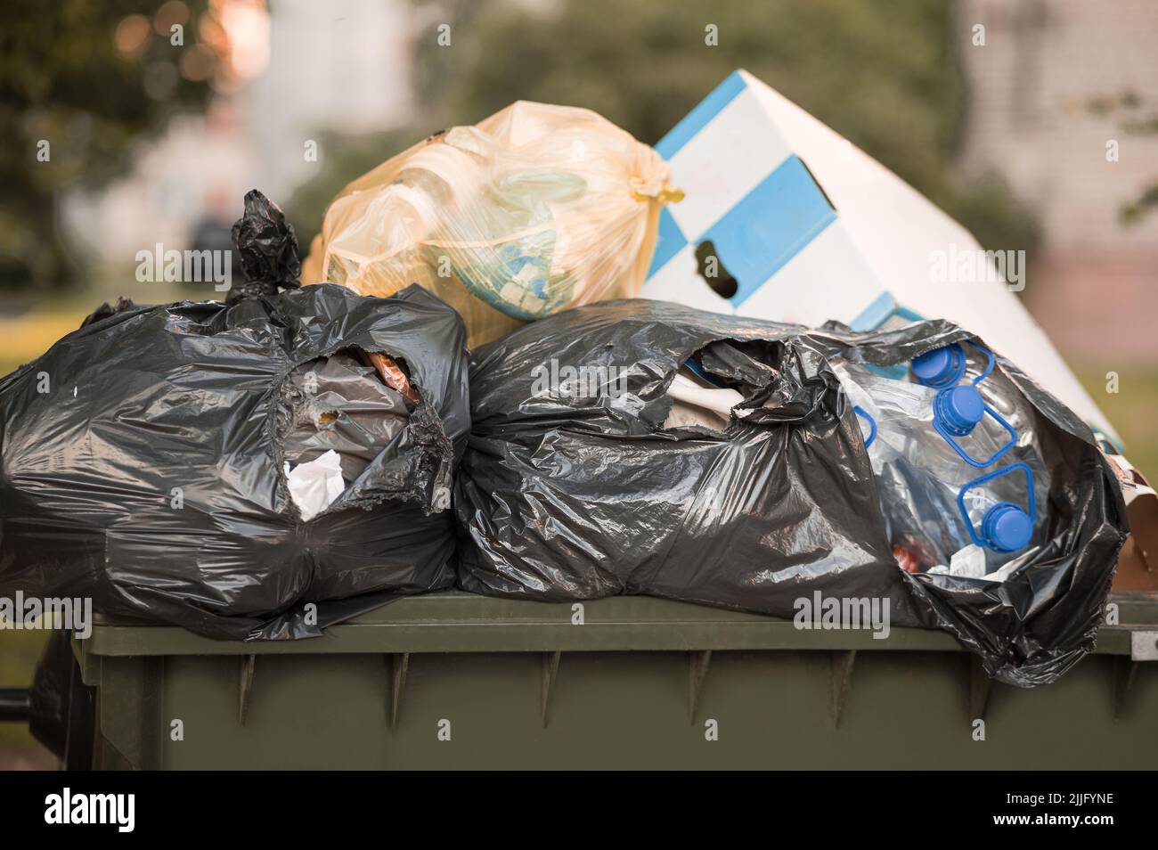 Overflowing trash bins full of rubbish and waste on the street Stock ...