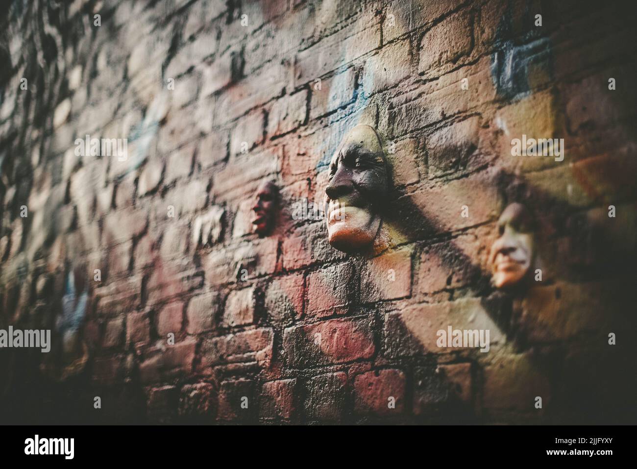 A face sculptures in the wall Stock Photo - Alamy