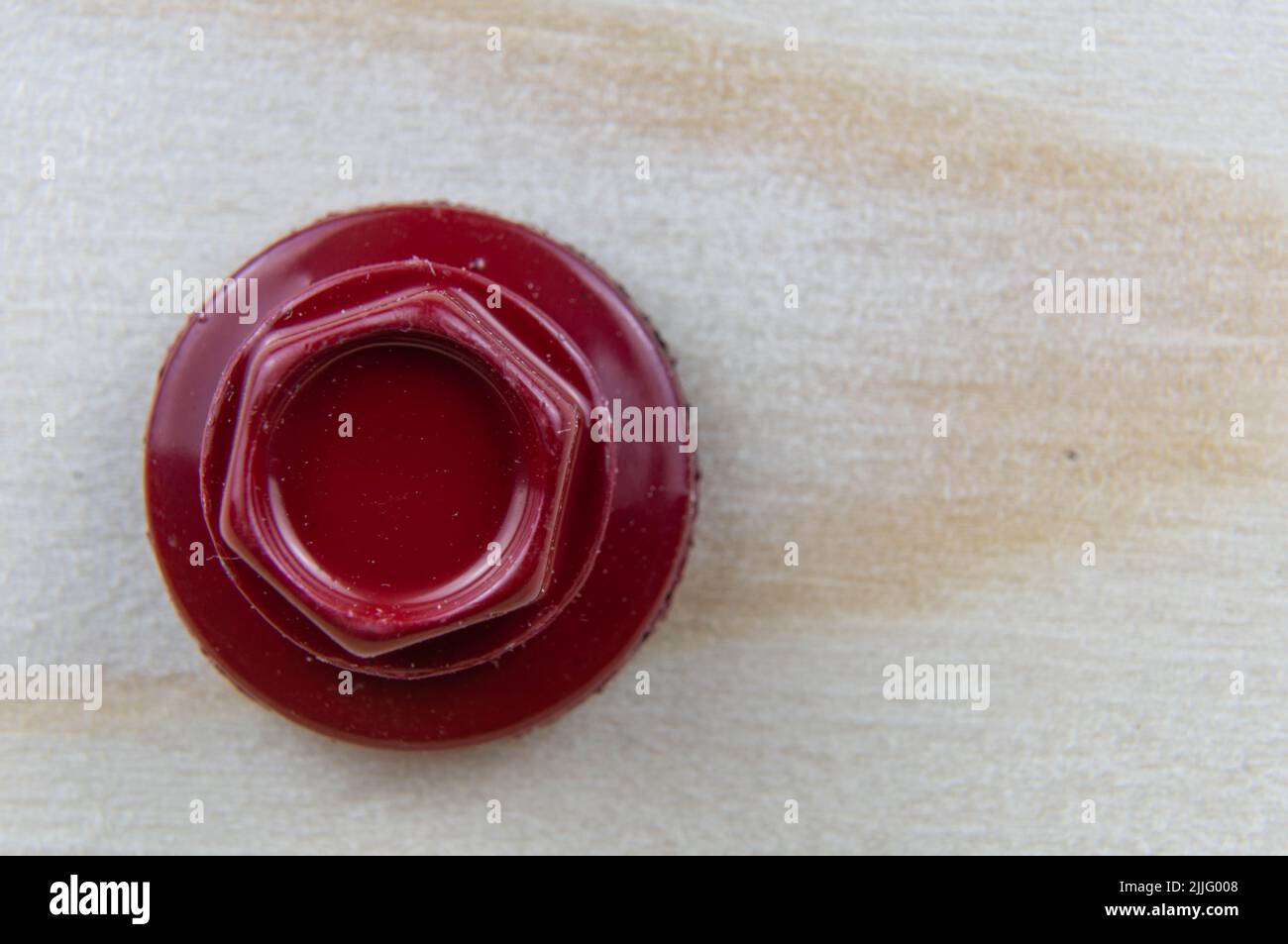 Close-up of the head of a red roofing self-tapping screw screwed into a ...