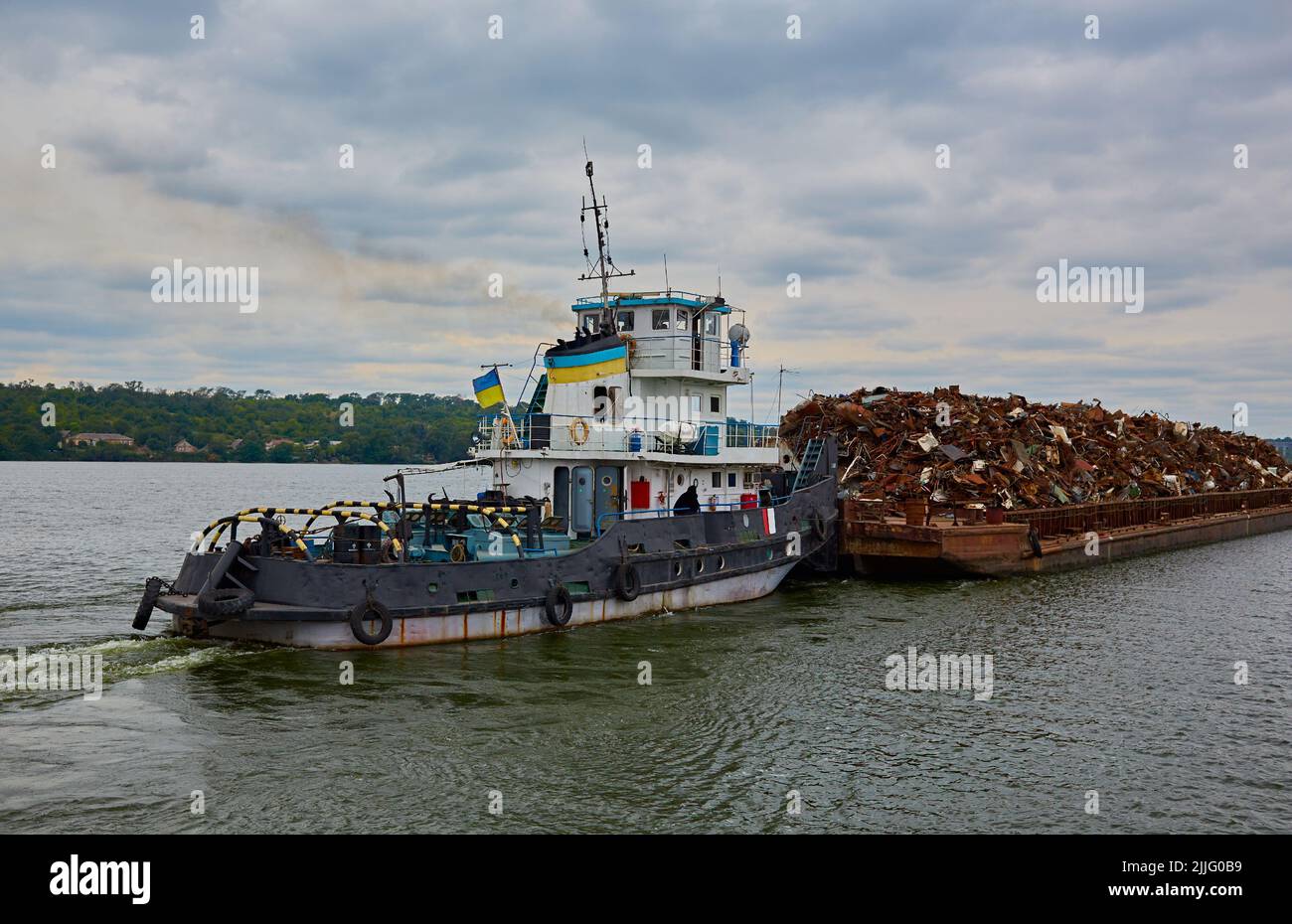Transportation industry. Ship barge transports scrap metal and sand ...