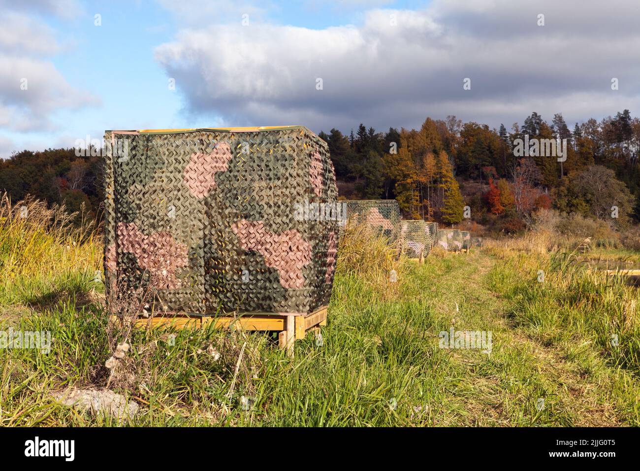 Shelter, a hiding place for bird hunting this side a colorful hill in ...