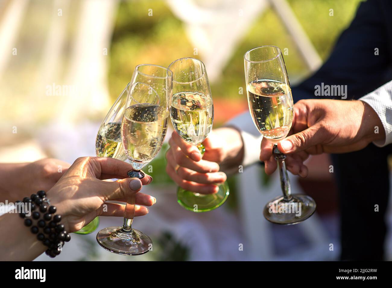 The wedding guests cheering with champagne glasses Stock Photo - Alamy