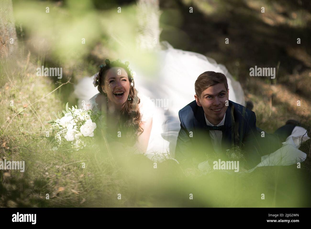 A happy caucasian couple taking a wedding photoshoot in a forest Stock ...