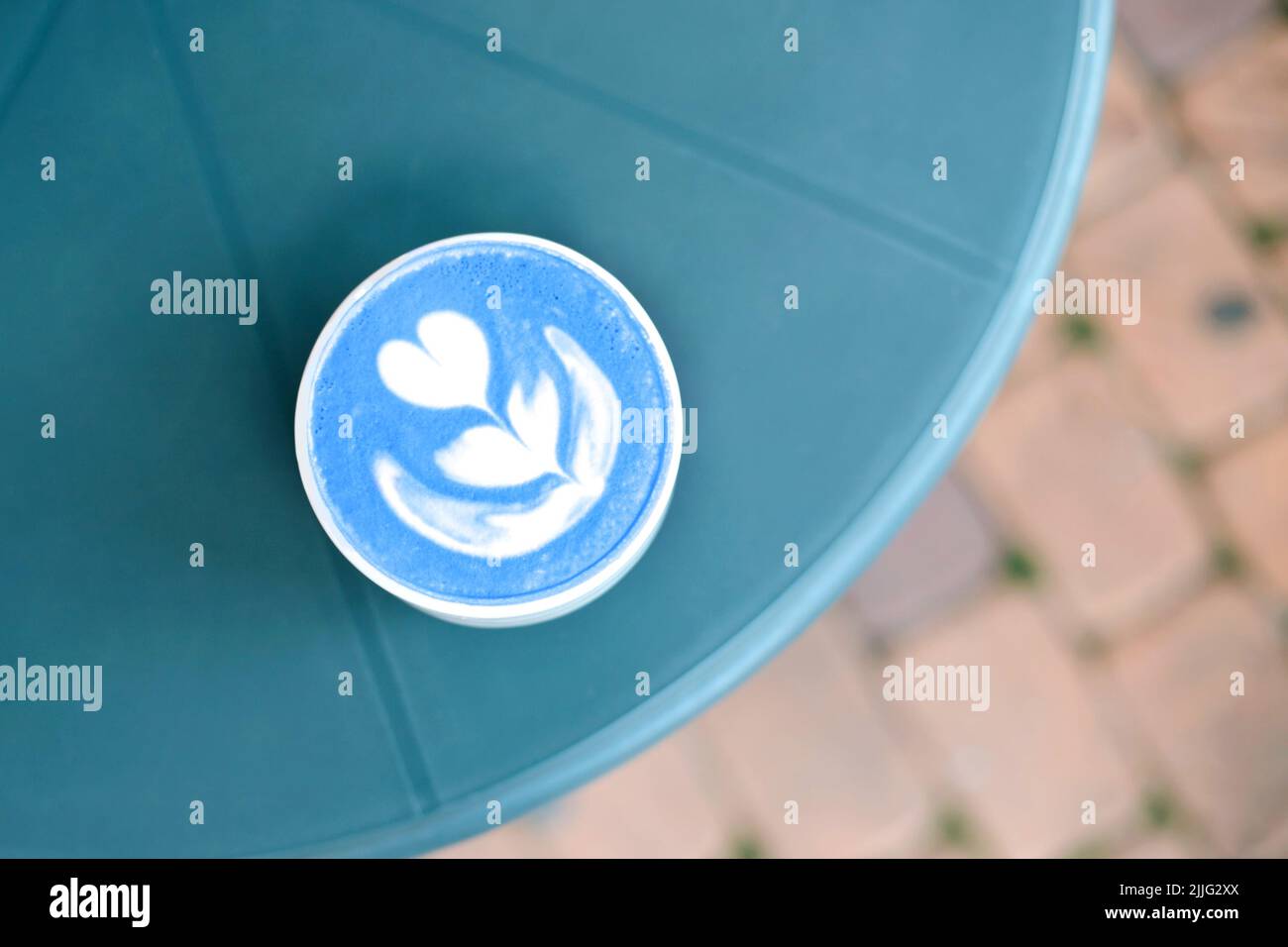 Blue matcha with frothy foam, coffee cup top view is on the plastic ...