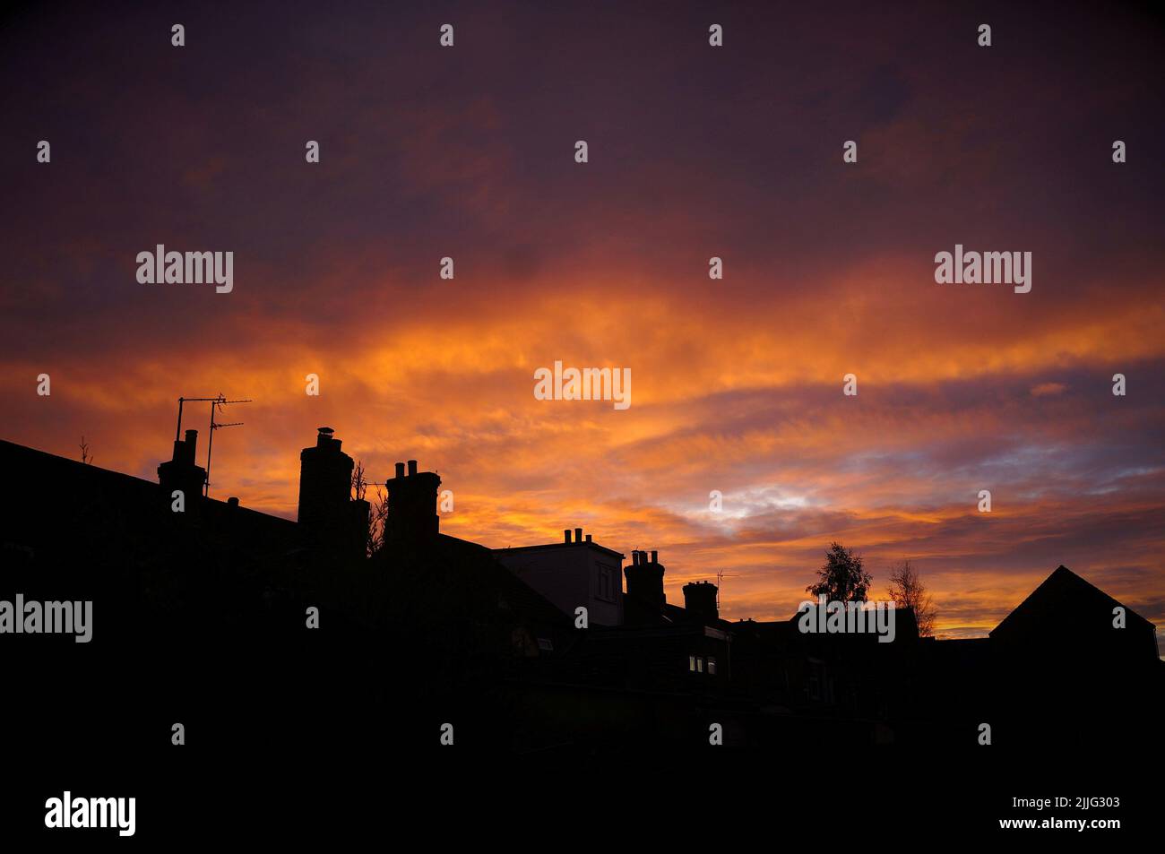 Autumn sunset over rooftops Stock Photo - Alamy