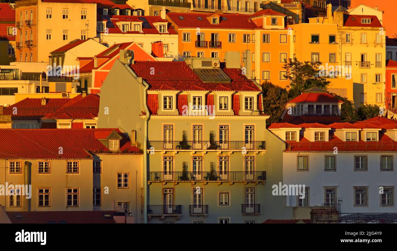 The colored house buildings facade view under sunset warm light, Lisbon ...