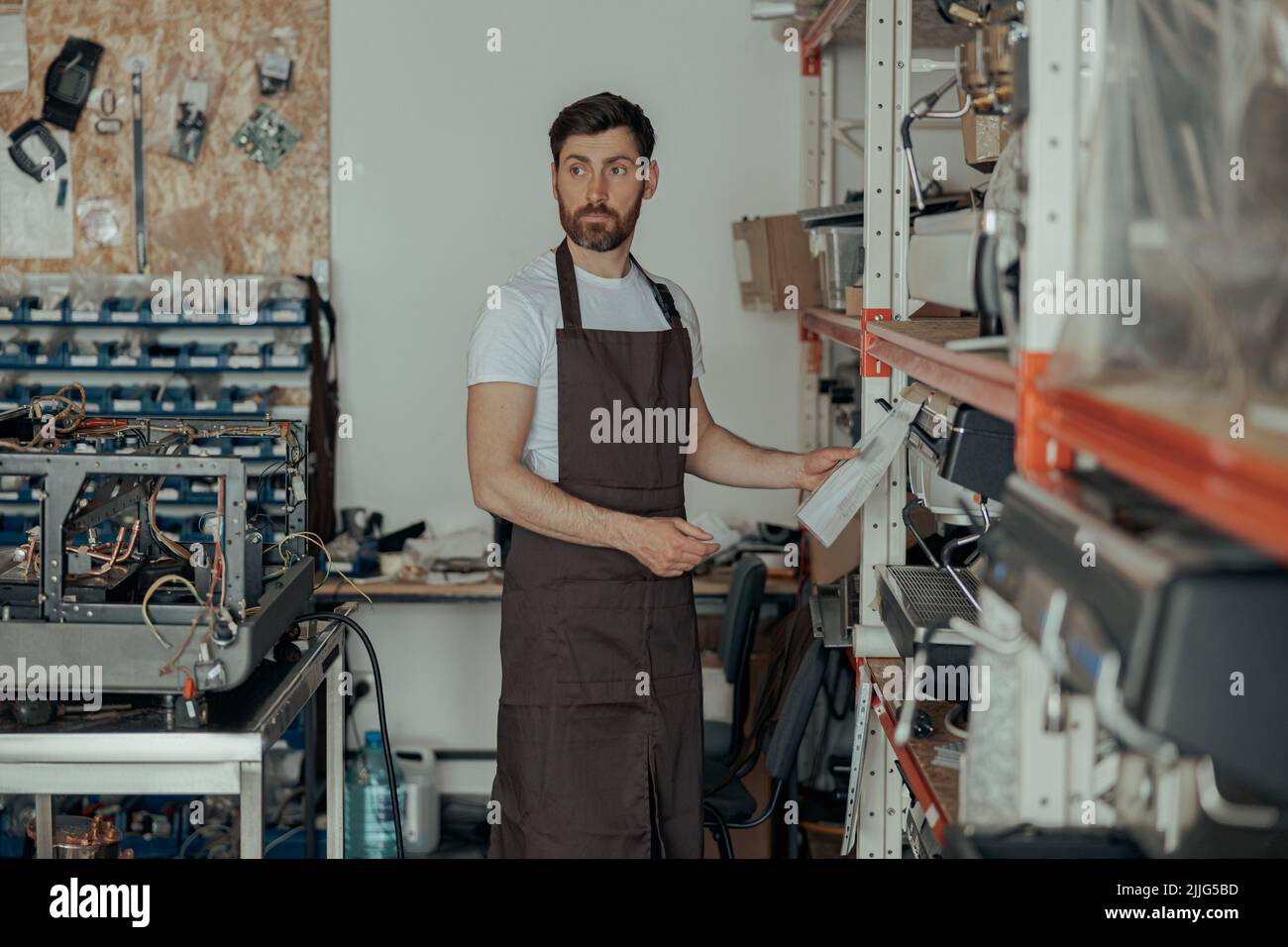 Man fixing coffee machine hi-res stock photography and images - Alamy