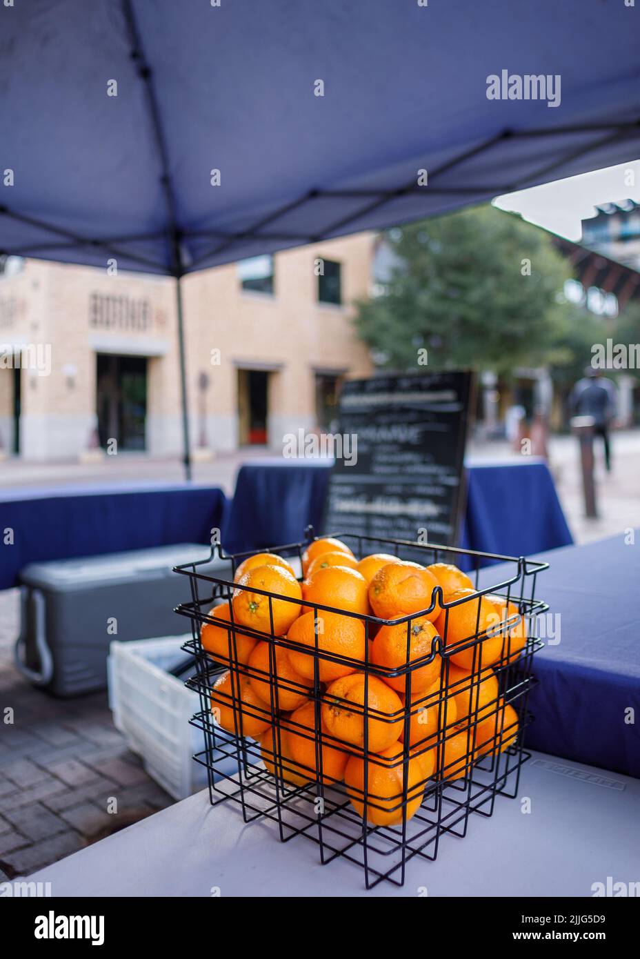 A basket of oranges in a booth at the farmers market at the Historic ...