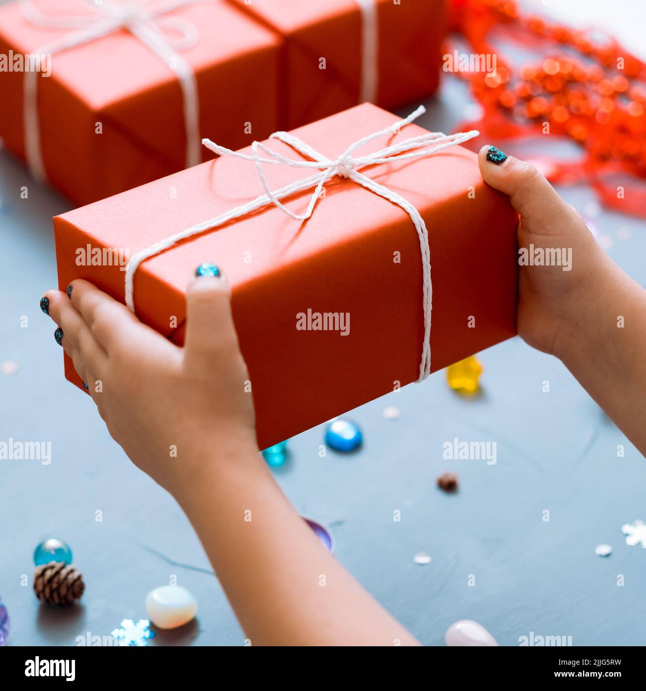 present mother father hand red gift holiday reward Stock Photo - Alamy