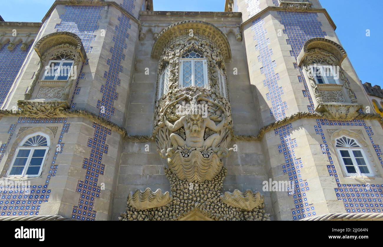 The facade of The Pena Palace in Sintra with demon statue detail ...