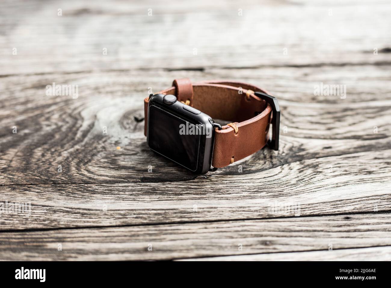 Genuine brown leather watch strap on wood background, Craftsmanship ...
