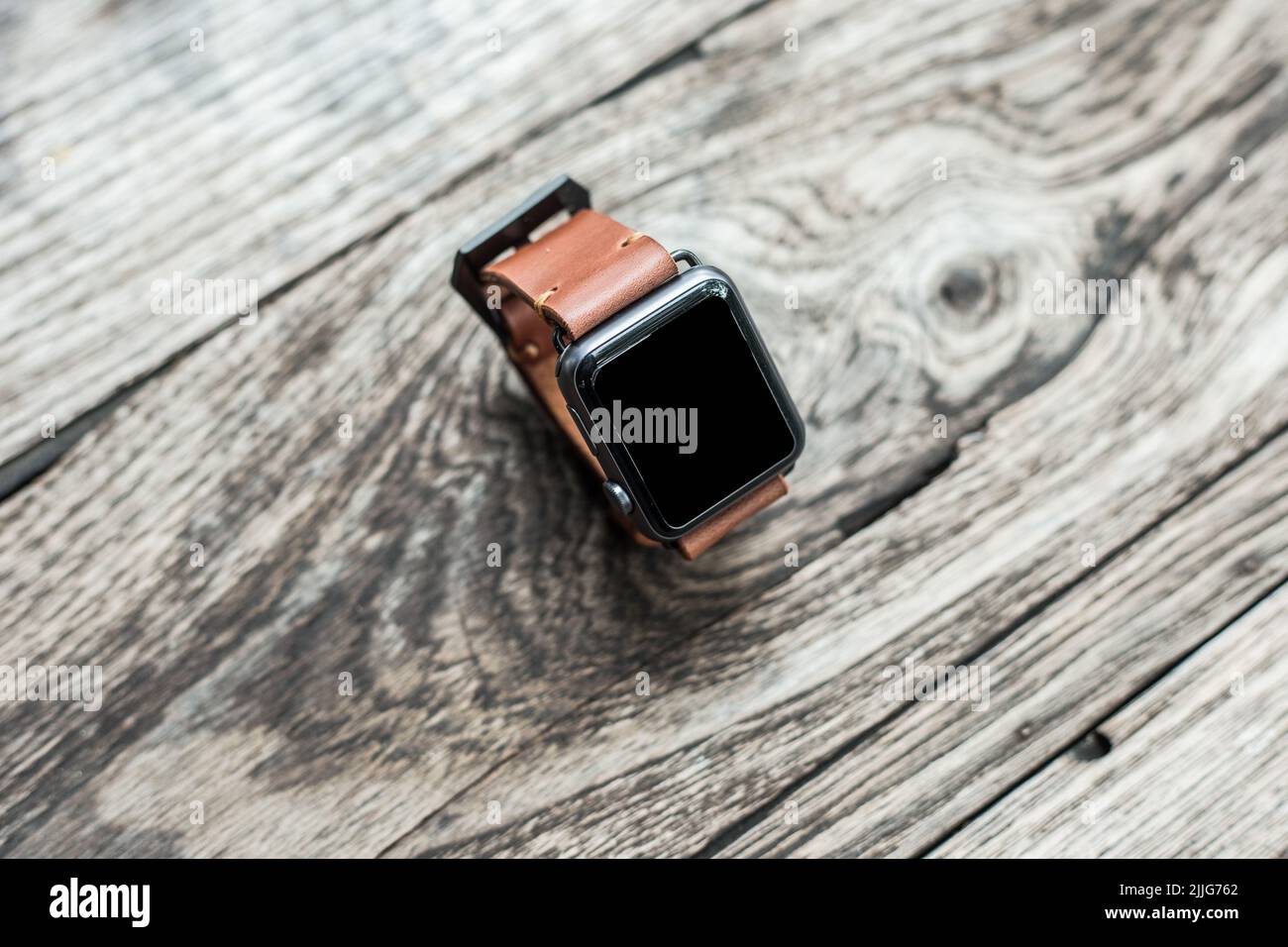 Genuine brown leather watch strap on wood background, Craftsmanship ...