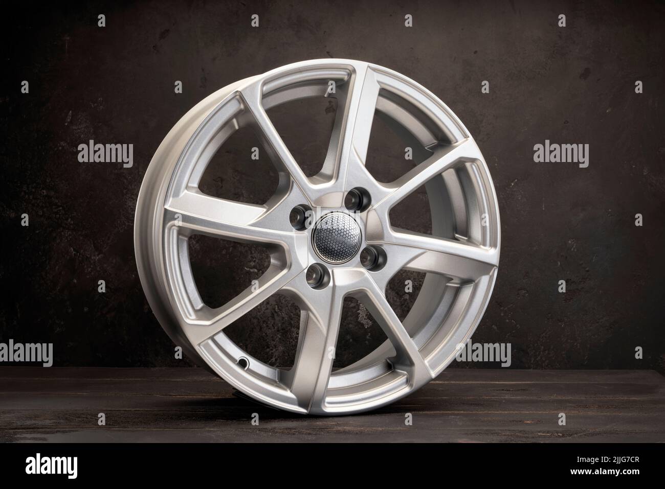 new grey alloy wheels on a dark textured black background. a wheel for ...