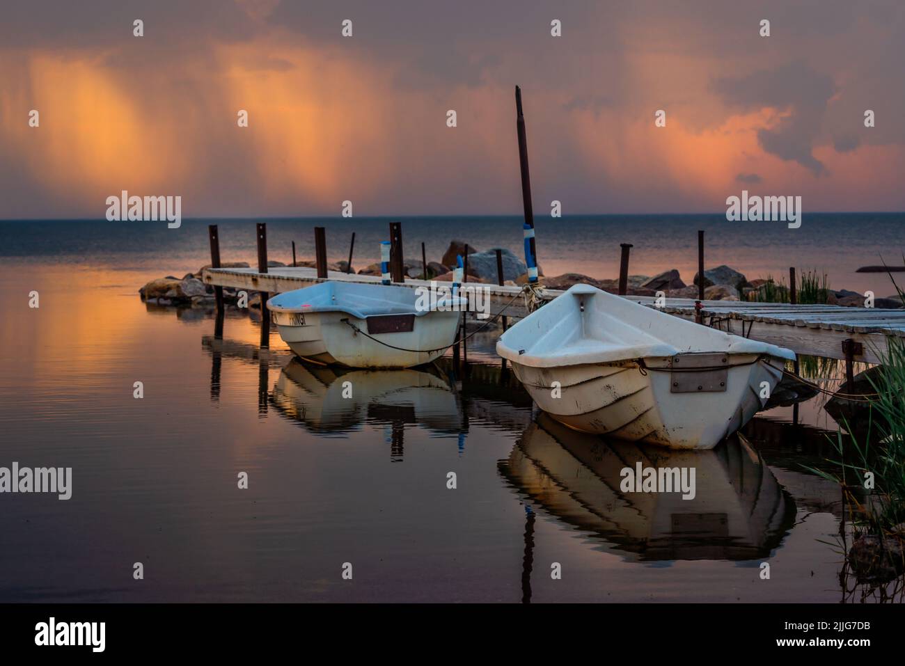 Two lonely local fishing boats at an old rustick wooden dock in ...