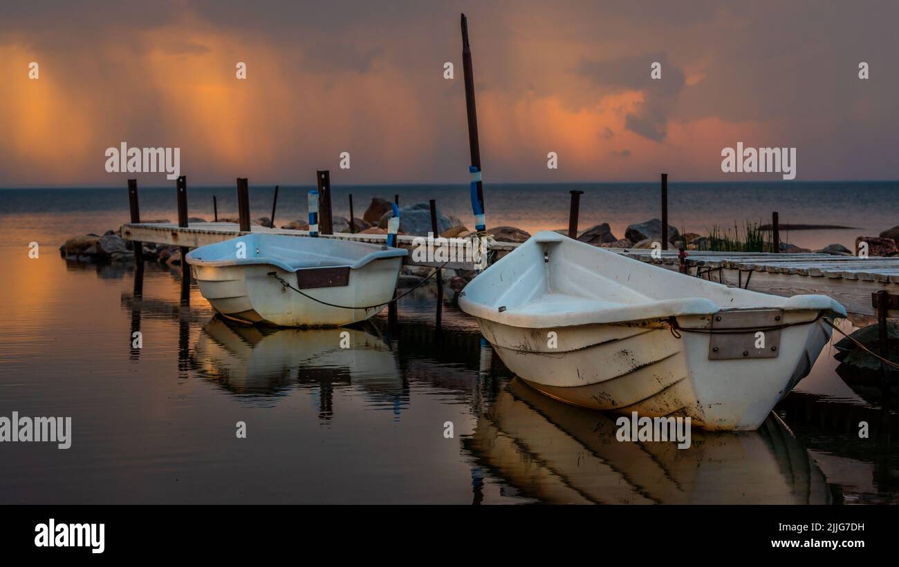 Two lonely local fishing boats at an old rustick wooden dock in ...