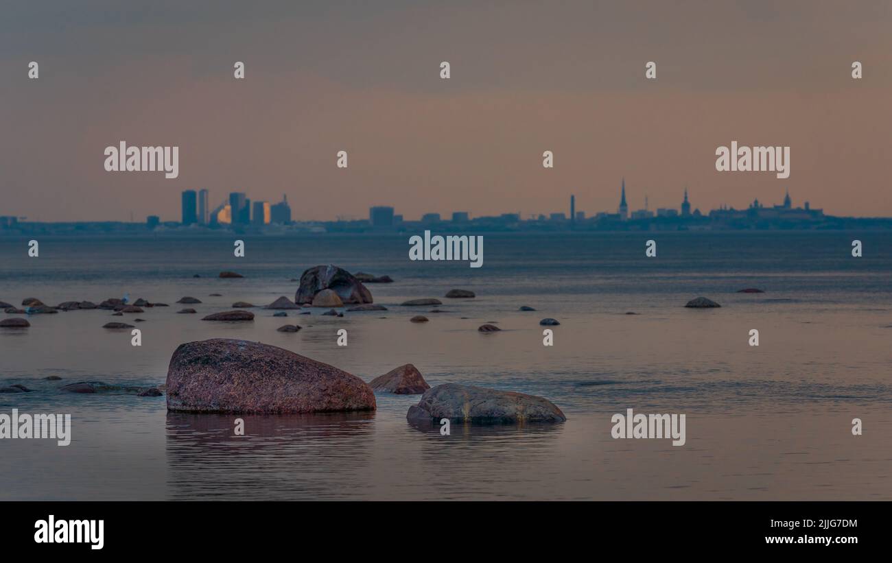 Rocks in the calm Baltic Sea coast on the background of the silhouette ...