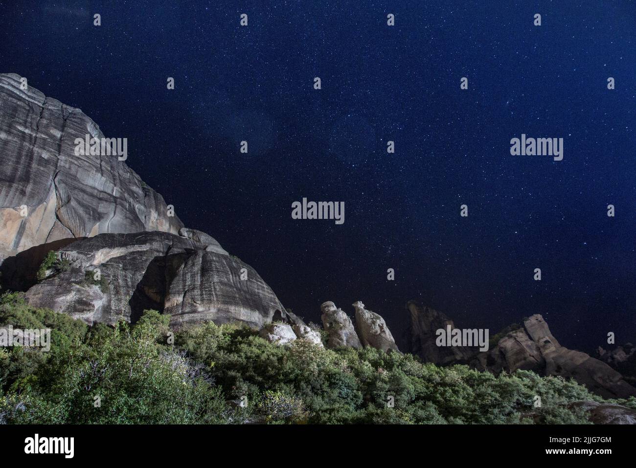 The conglomerate formation of Meteora during night, dark sky with stars ...