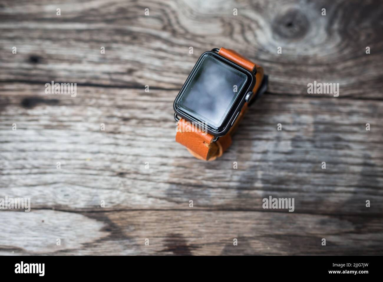 Genuine brown leather watch strap on wood background, Craftsmanship ...